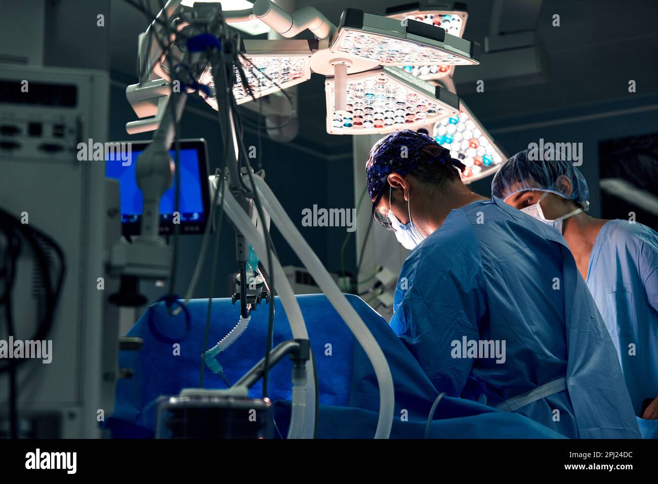 Group of surgeons doing surgery in a modern hospital operating room ...