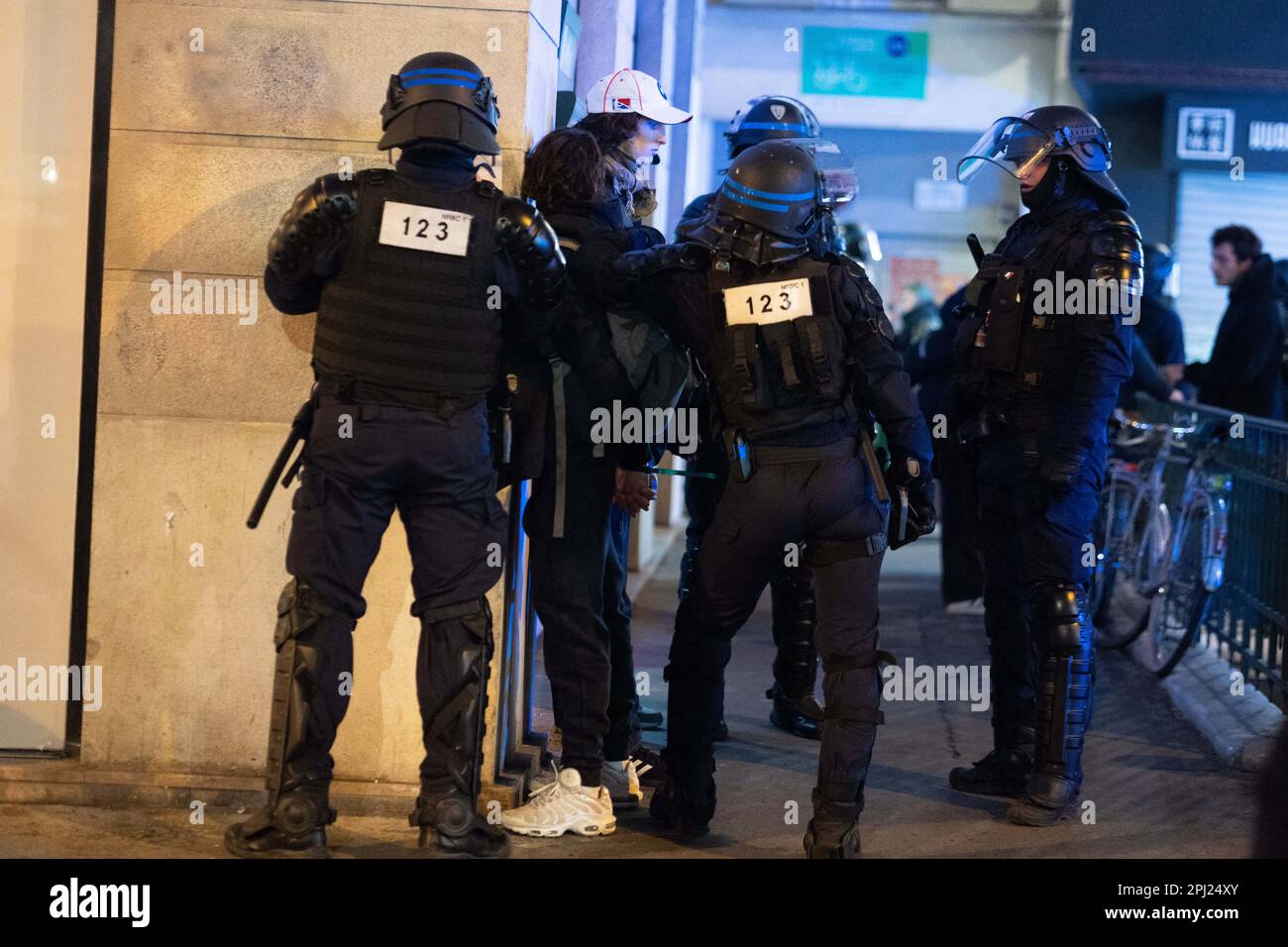 Paris, France. 30th Mar, 2023. Riot police arrest protesters during a ...
