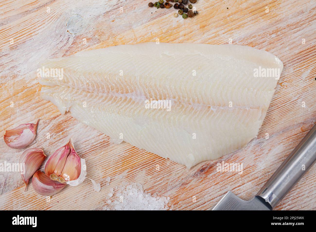 Uncooked fillet halibut fish with parsley and garlic Stock Photo - Alamy