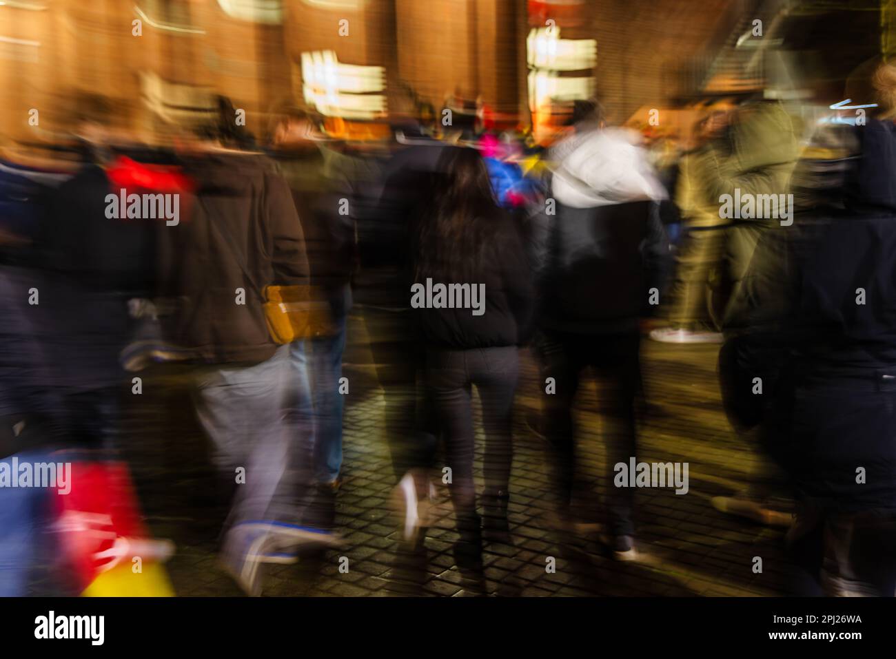 picture with camera made motion blur of a crowd of young people walking ...