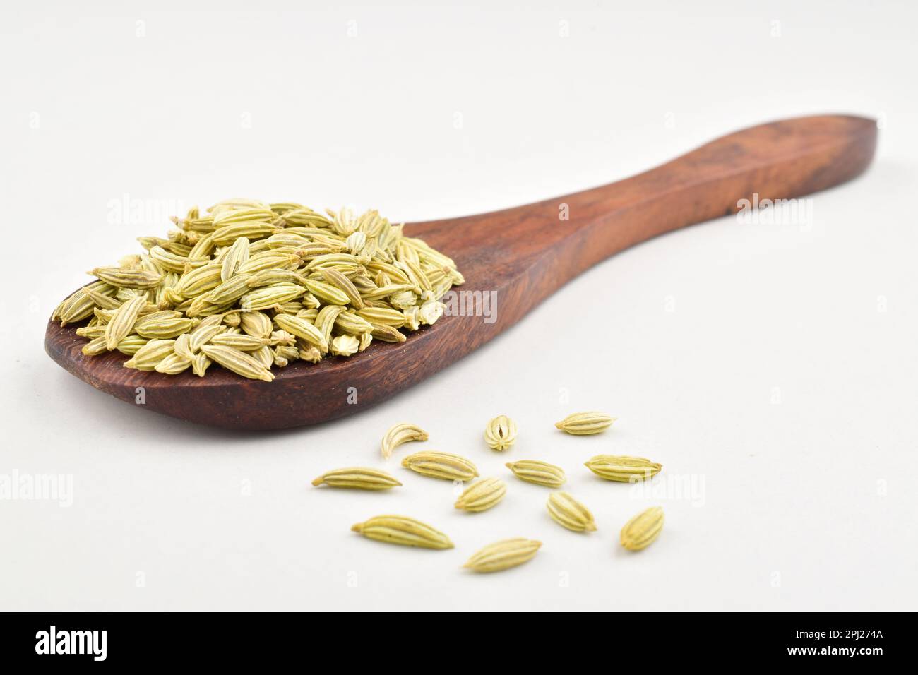 closeup of fennel seeds in spoon on white background Stock Photo - Alamy