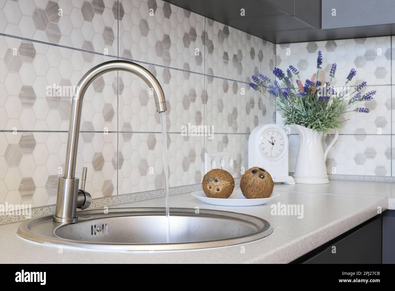 Faucet and steel sink close-up in the kitchen Stock Photo - Alamy