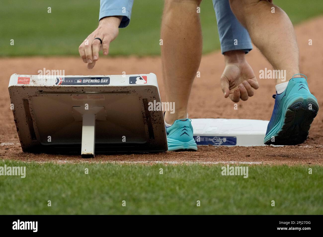 A member of the grounds crew changes bases between innings of an ...