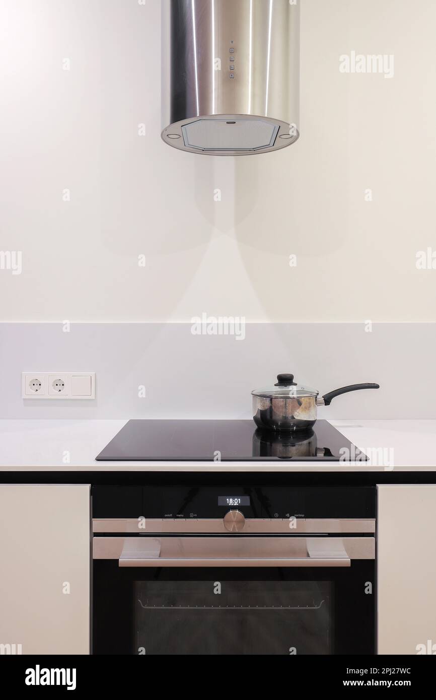 Frying pan on electric induction cooker in the kitchen Stock Photo - Alamy