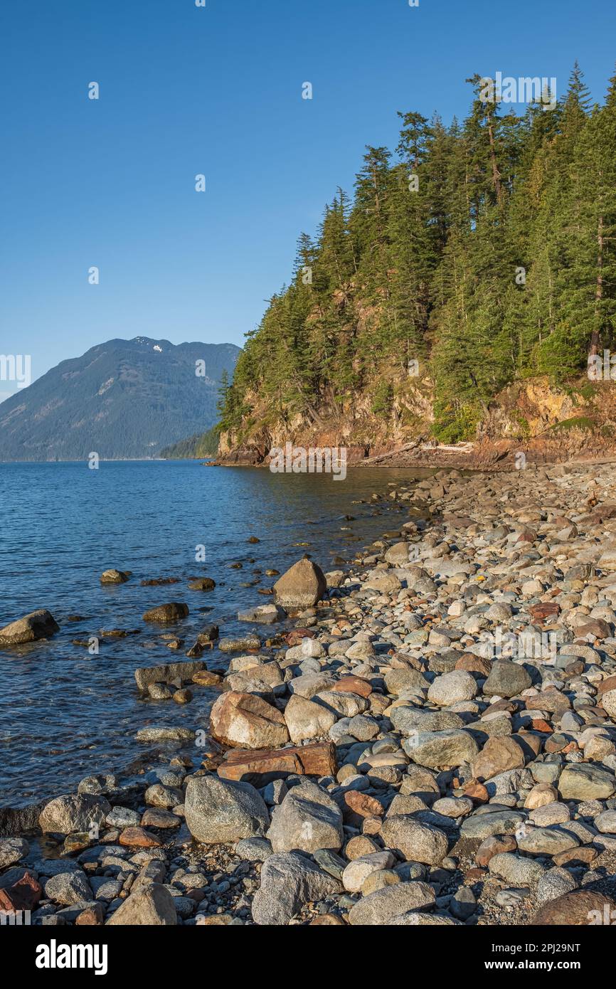 Harrison Lake and mountains at sunset BC Canada. River stone in water ...