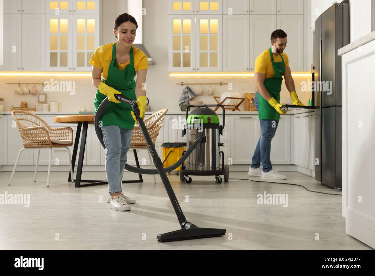 Professional janitors working in apartment. Cleaning service Stock ...