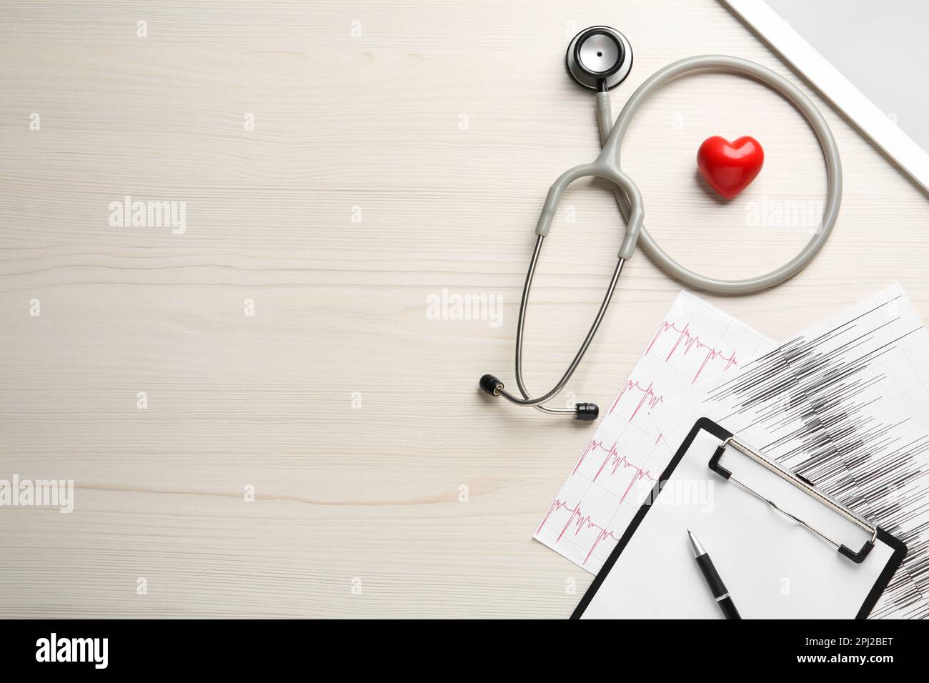 Flat lay composition with stethoscope and red heart on white wooden ...
