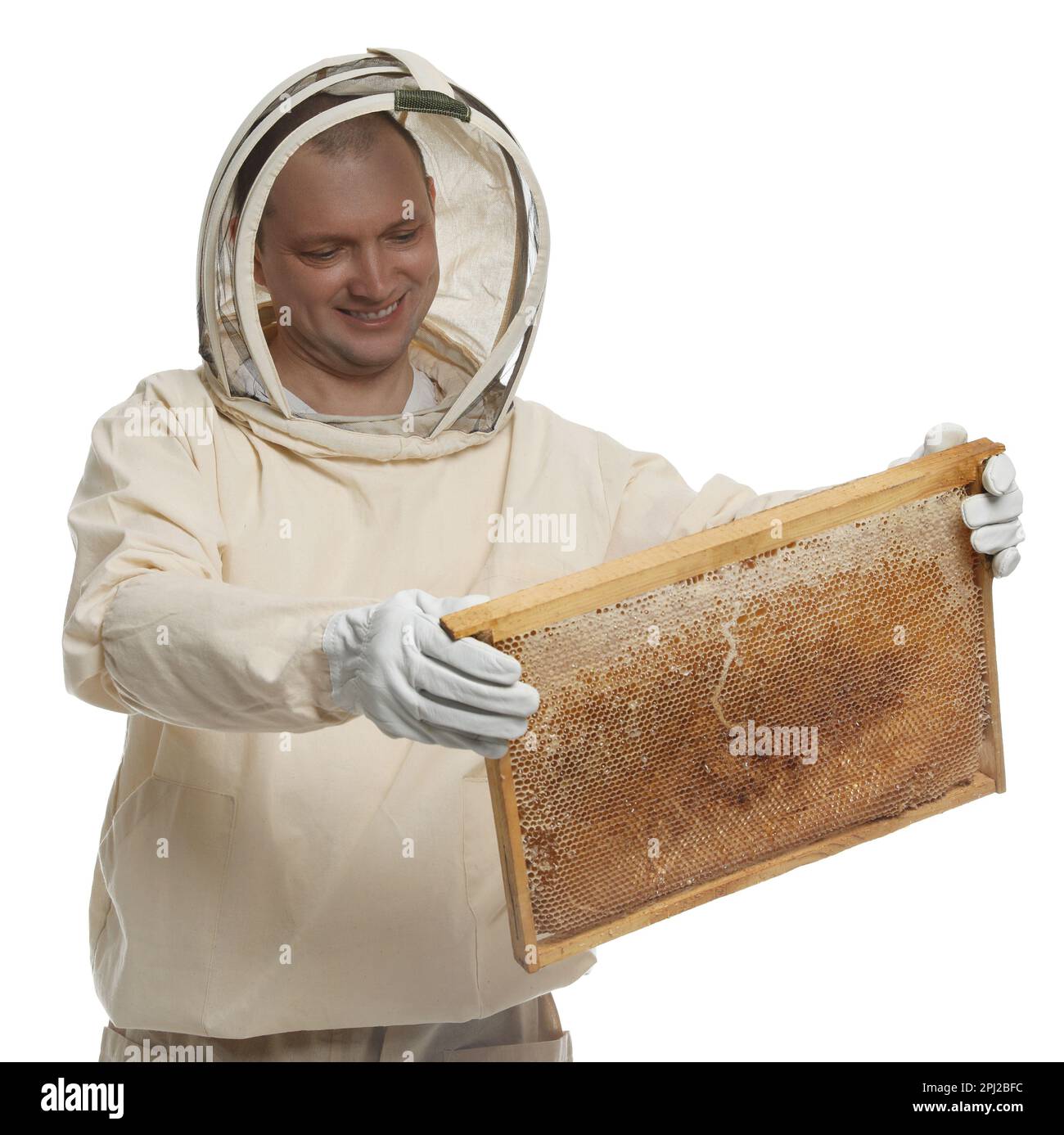 Beekeeper in uniform holding hive frame with honeycomb on white ...