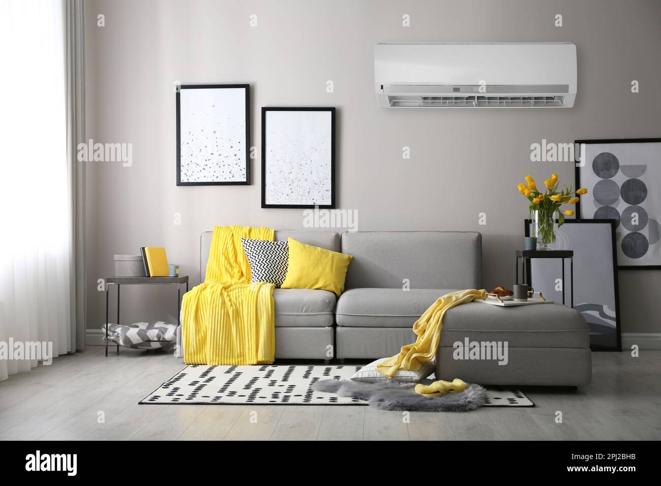 Modern air conditioner on light grey wall in living room with stylish ...