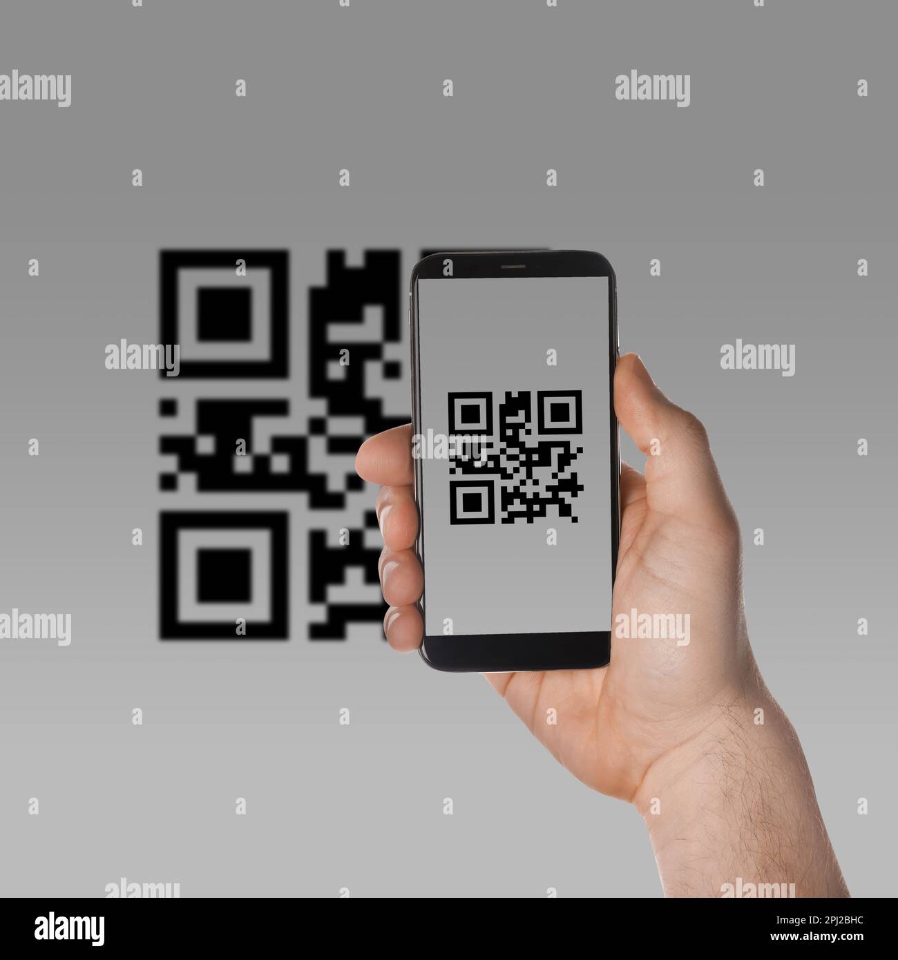 Man scanning QR code with smartphone on light grey background, closeup ...