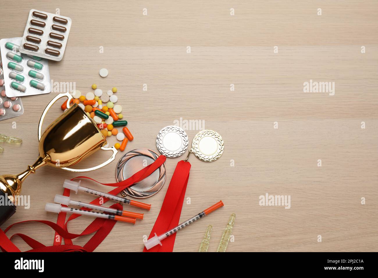 Flat lay composition with drugs on wooden table, space for text. Doping ...