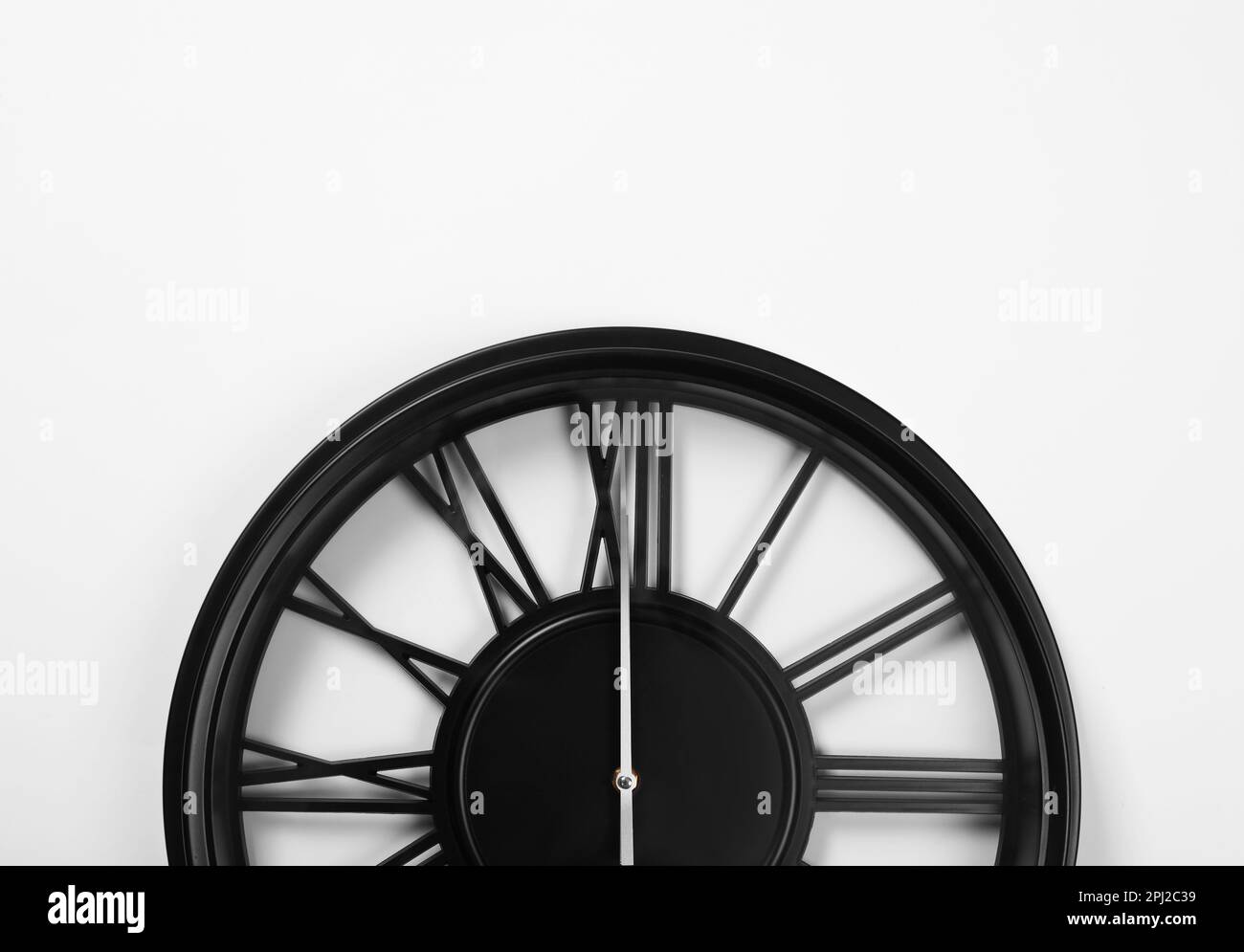 Stylish analog clock hanging on white wall, space for text Stock Photo ...