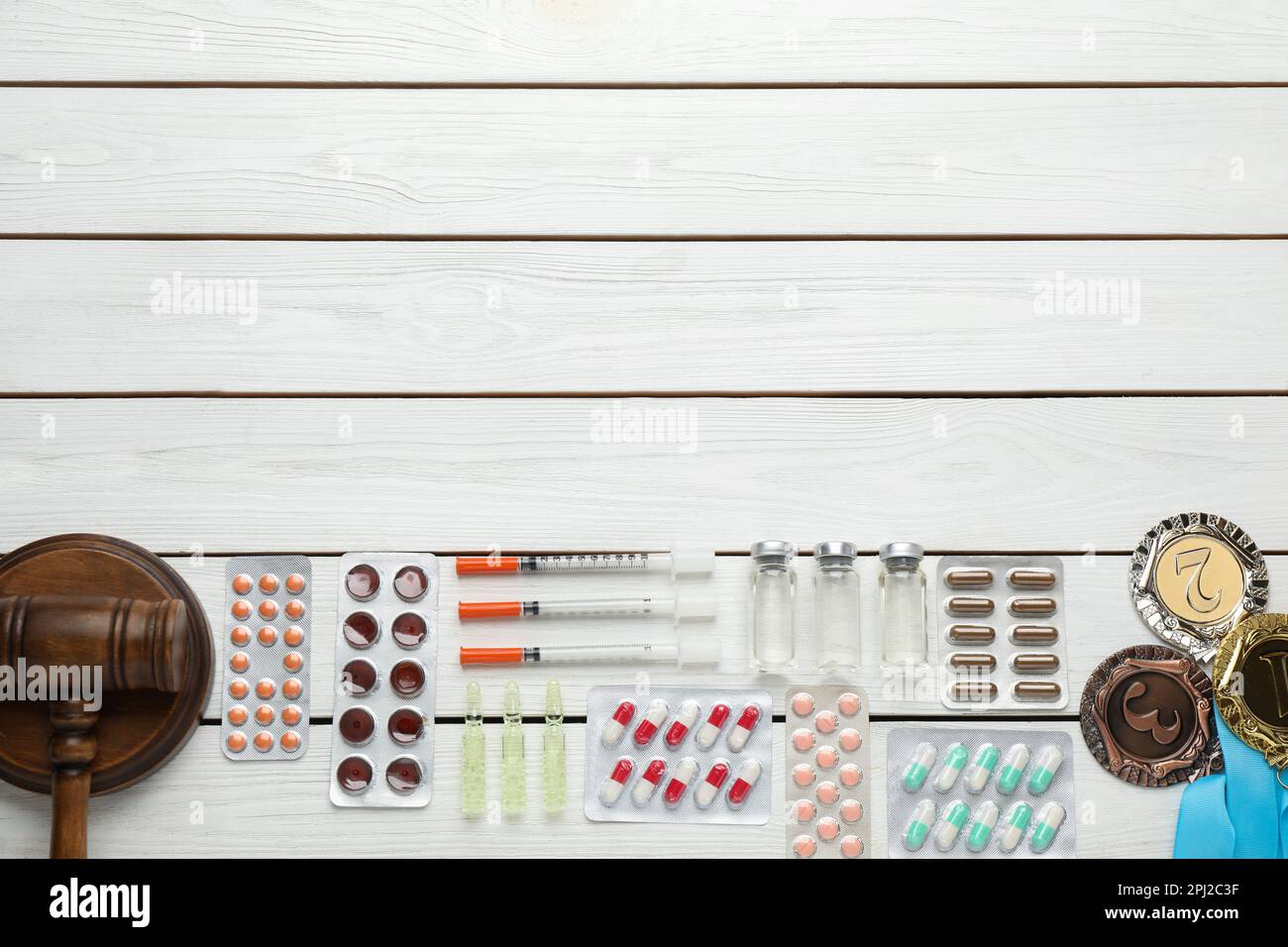 Flat lay composition with drugs on white wooden table, space for text ...