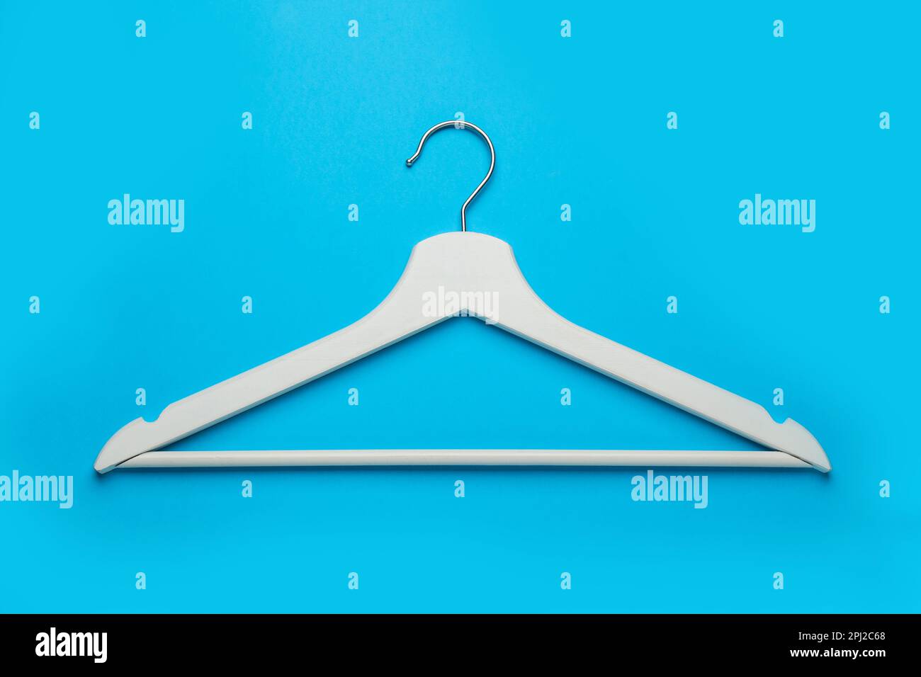 Empty wooden hanger on light blue background, top view Stock Photo - Alamy