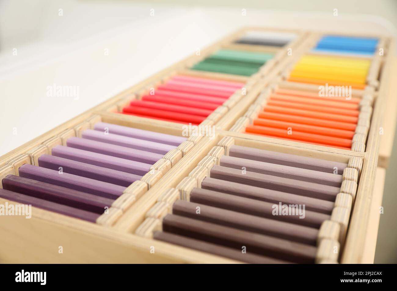 Wooden box with color tablets, closeup. Montessori toy Stock Photo - Alamy