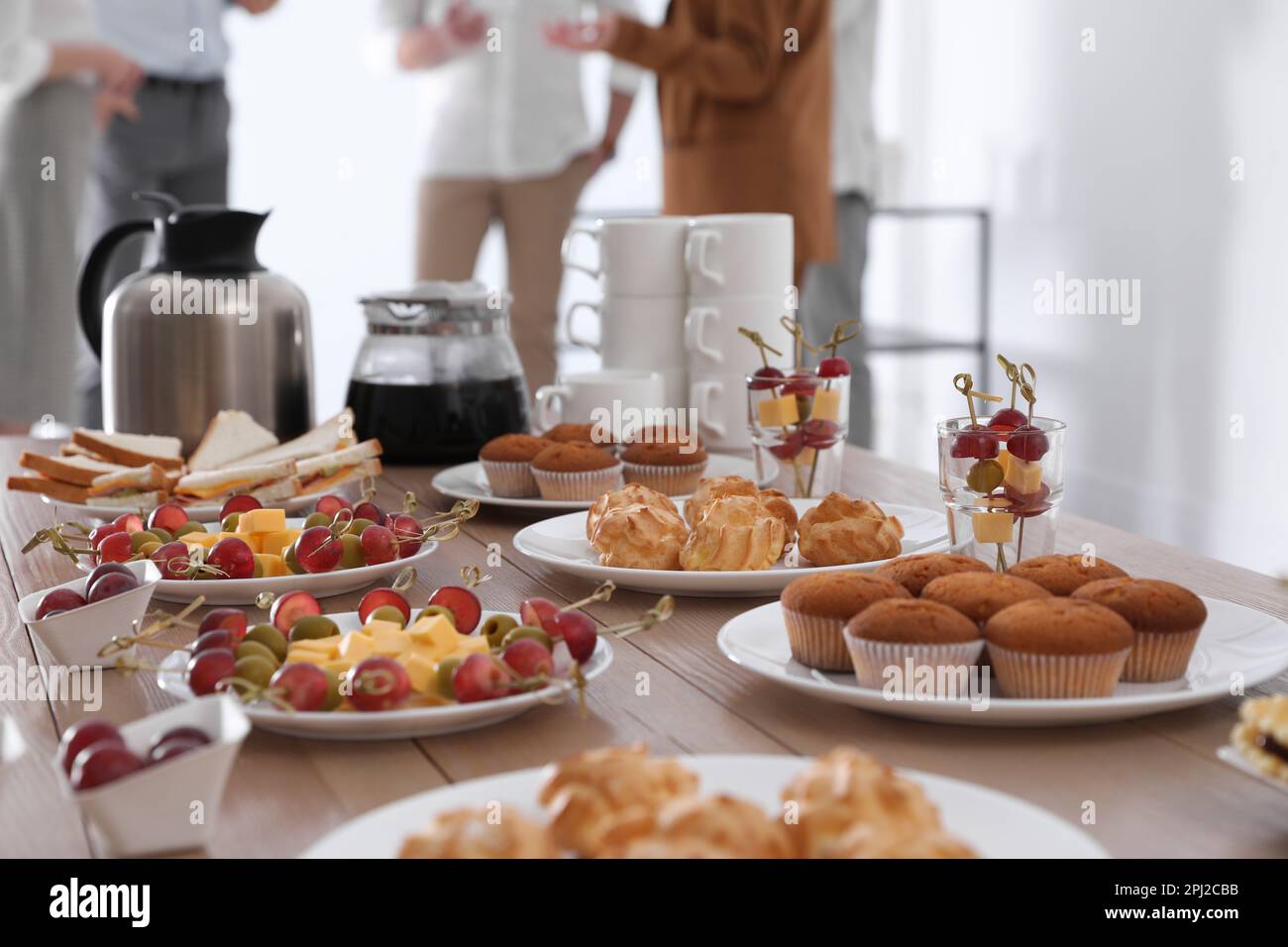 Table with different delicious snacks indoors. Coffee break Stock Photo ...