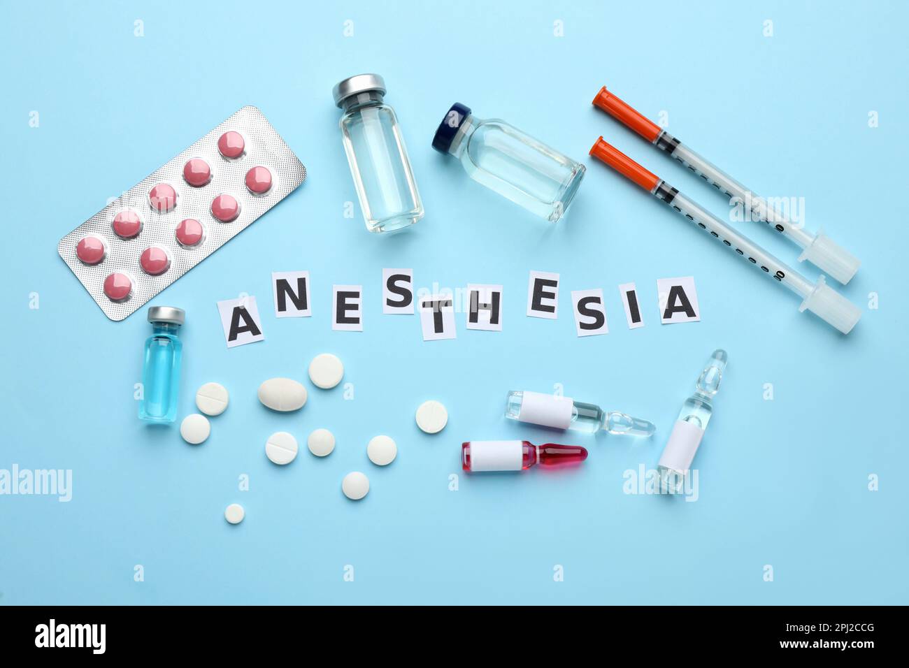 Flat lay composition with word Anesthesia and drugs on light blue ...