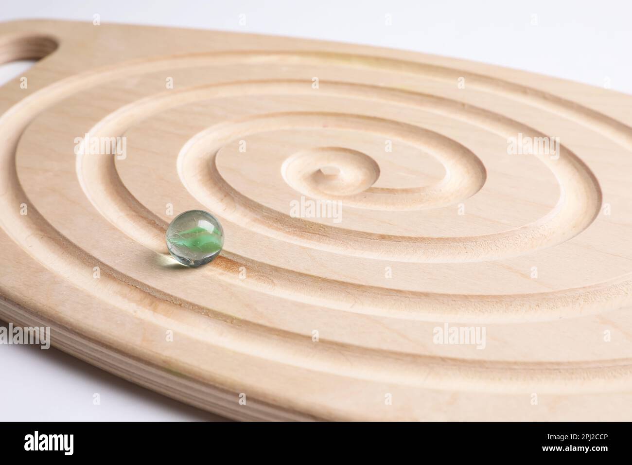 Wooden labyrinth balance board on white background, closeup. Montessori ...