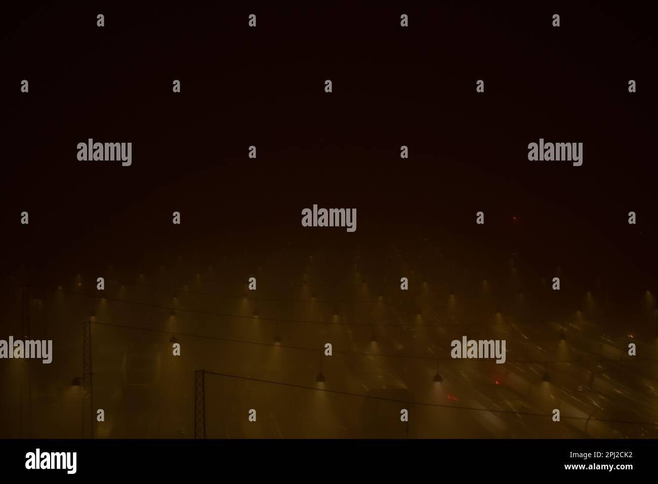 Yellow lights in a dark and foggy city with black background Stock ...