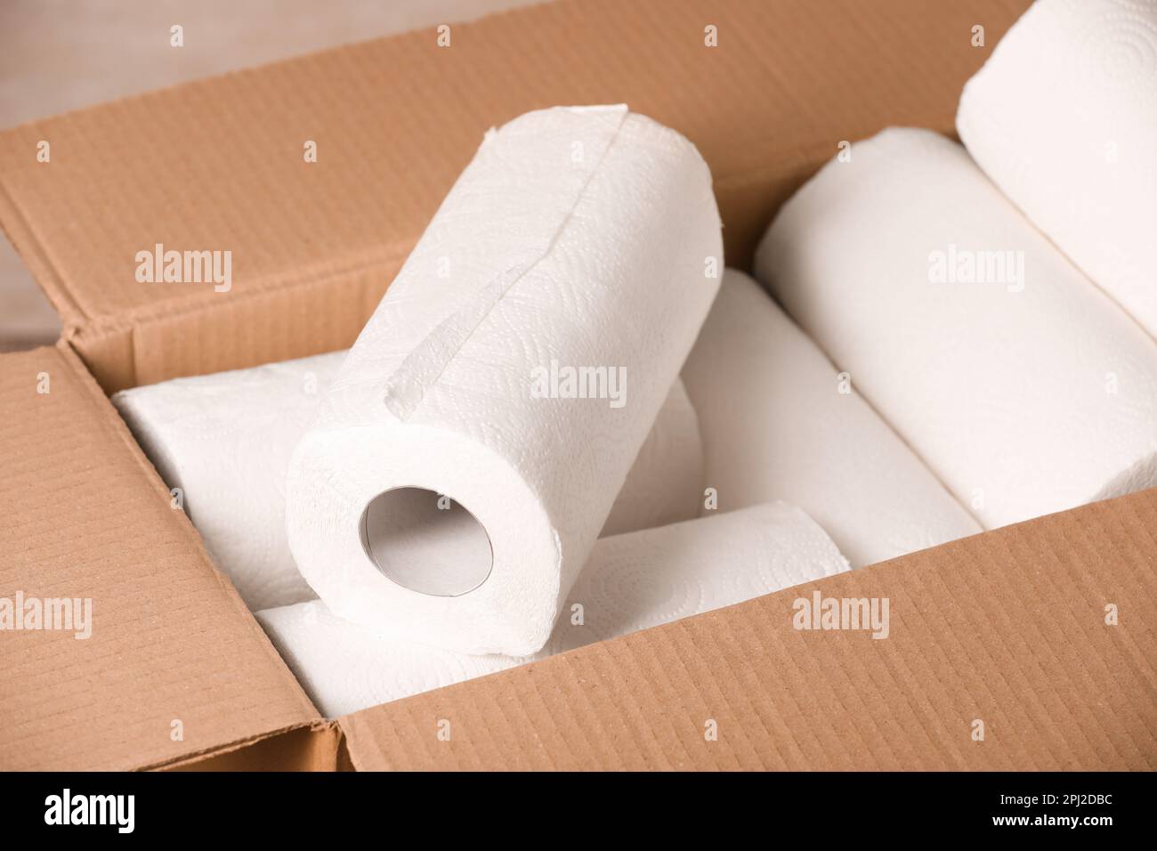 Rolls of white paper towels in cardboard box, closeup Stock Photo - Alamy