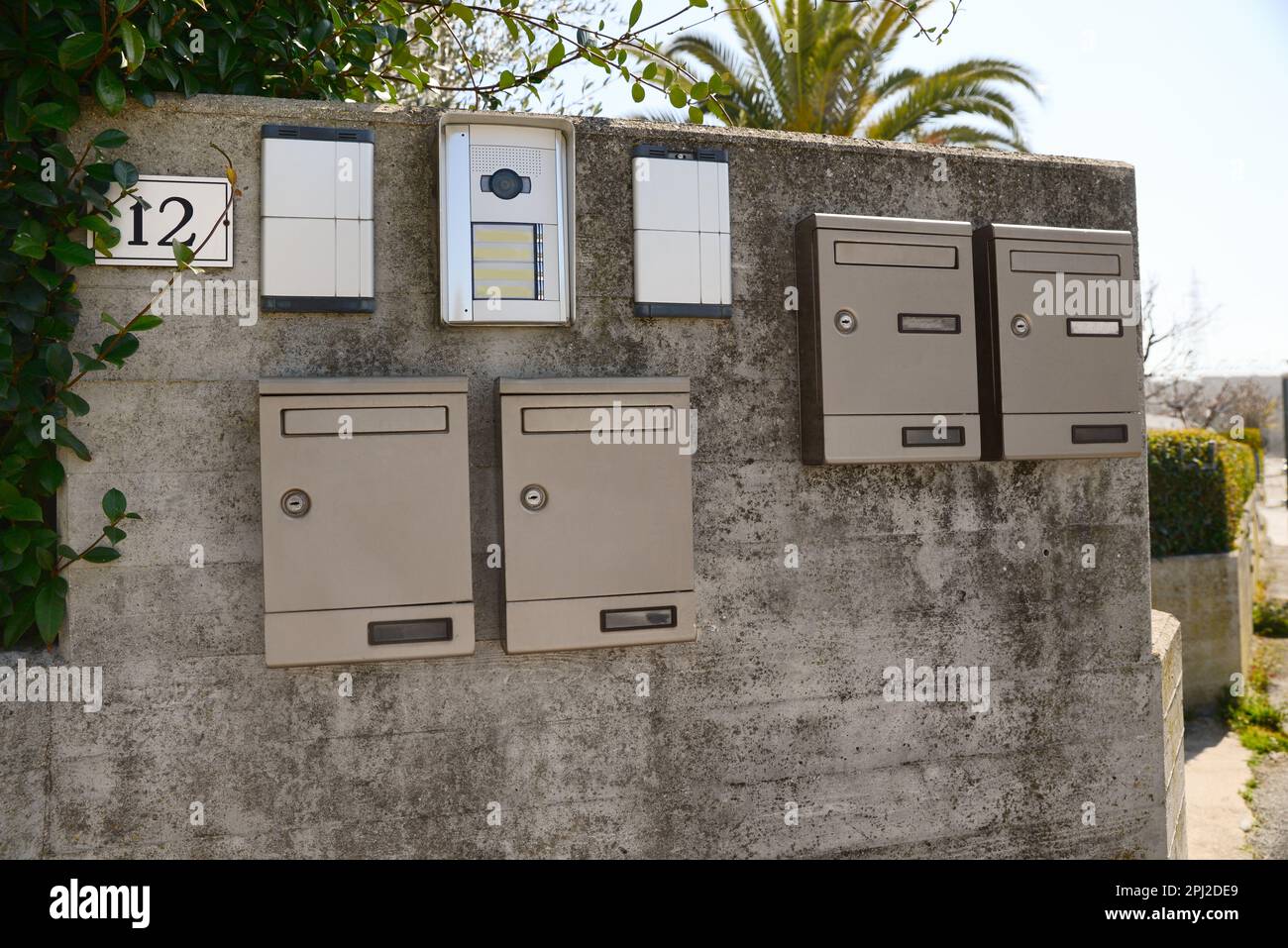 Mail boxes and intercoms on grey concrete wall outdoors Stock Photo - Alamy
