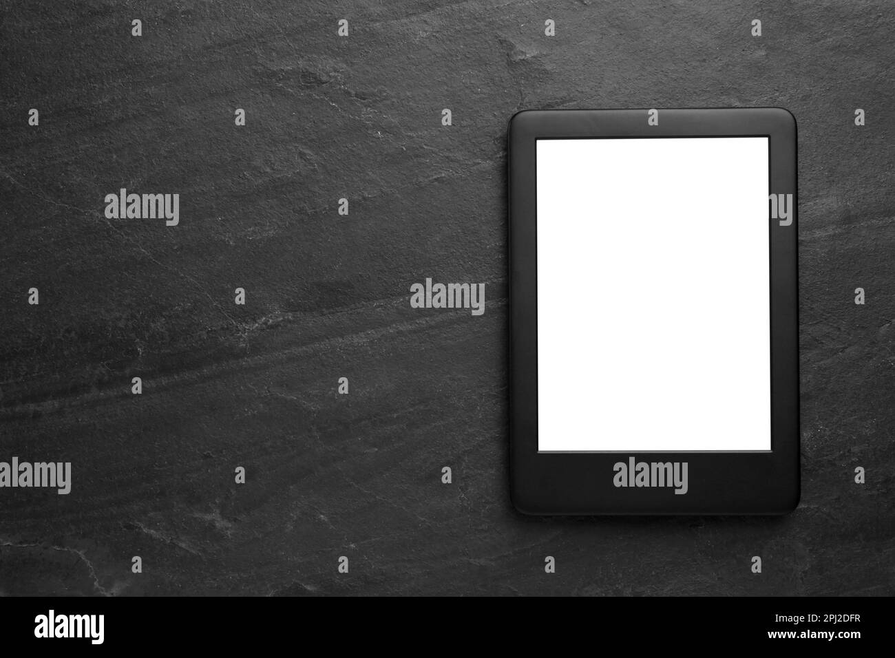 Modern e-book reader with blank screen on black table, top view. Space ...