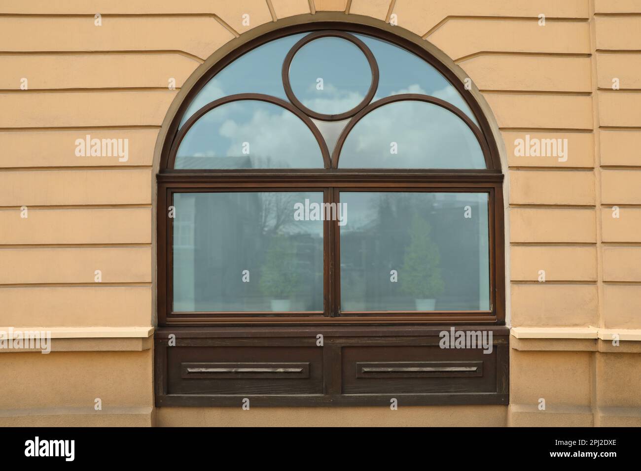 Wall of beige stone building with beautiful wooden arch window Stock ...