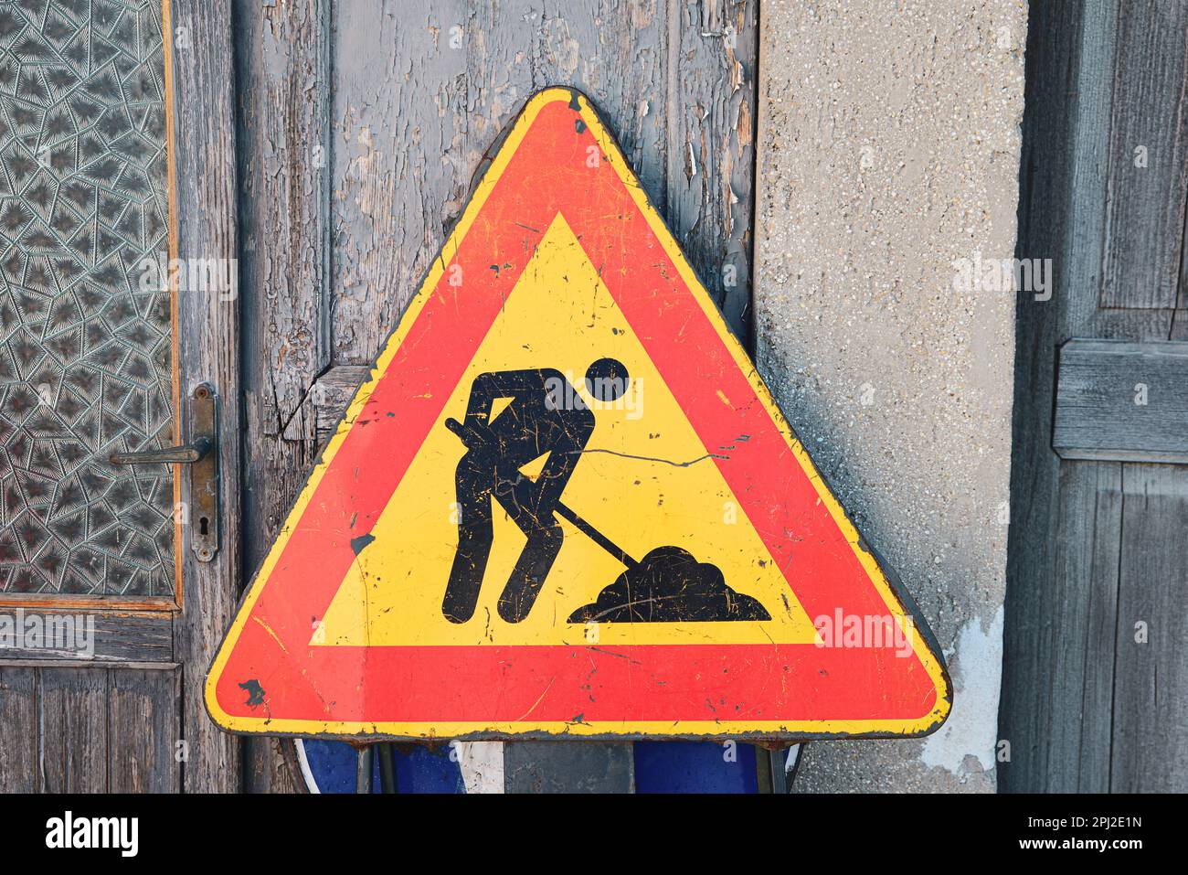 Different traffic signs near old wooden door Stock Photo - Alamy