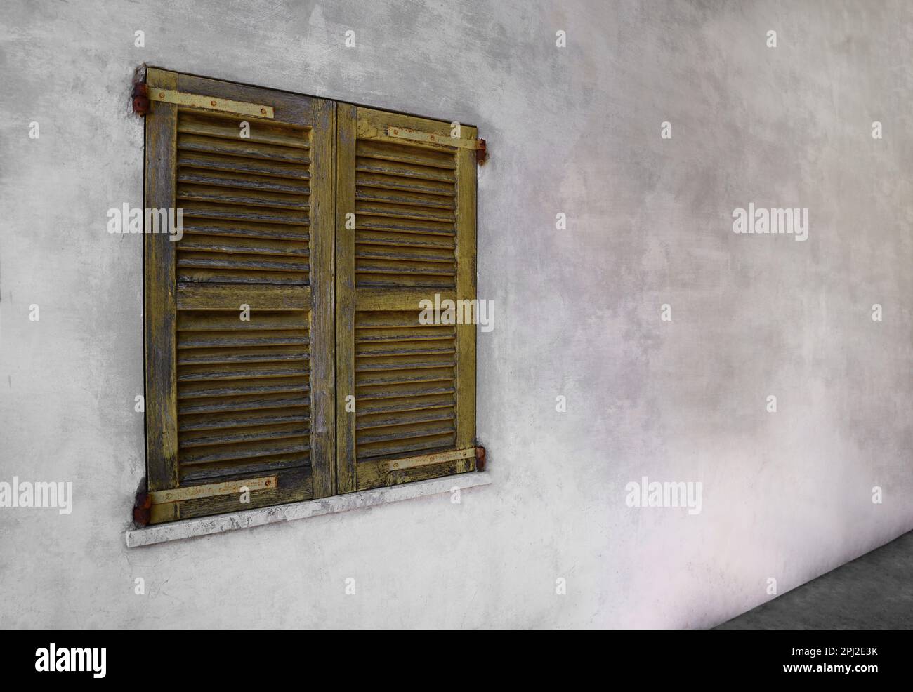 Window with old wooden shutters on concrete wall Stock Photo - Alamy