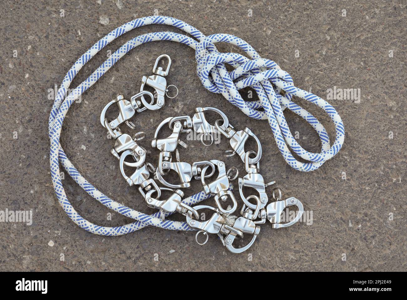 Climbing rope with carabiners on asphalt, top view Stock Photo - Alamy