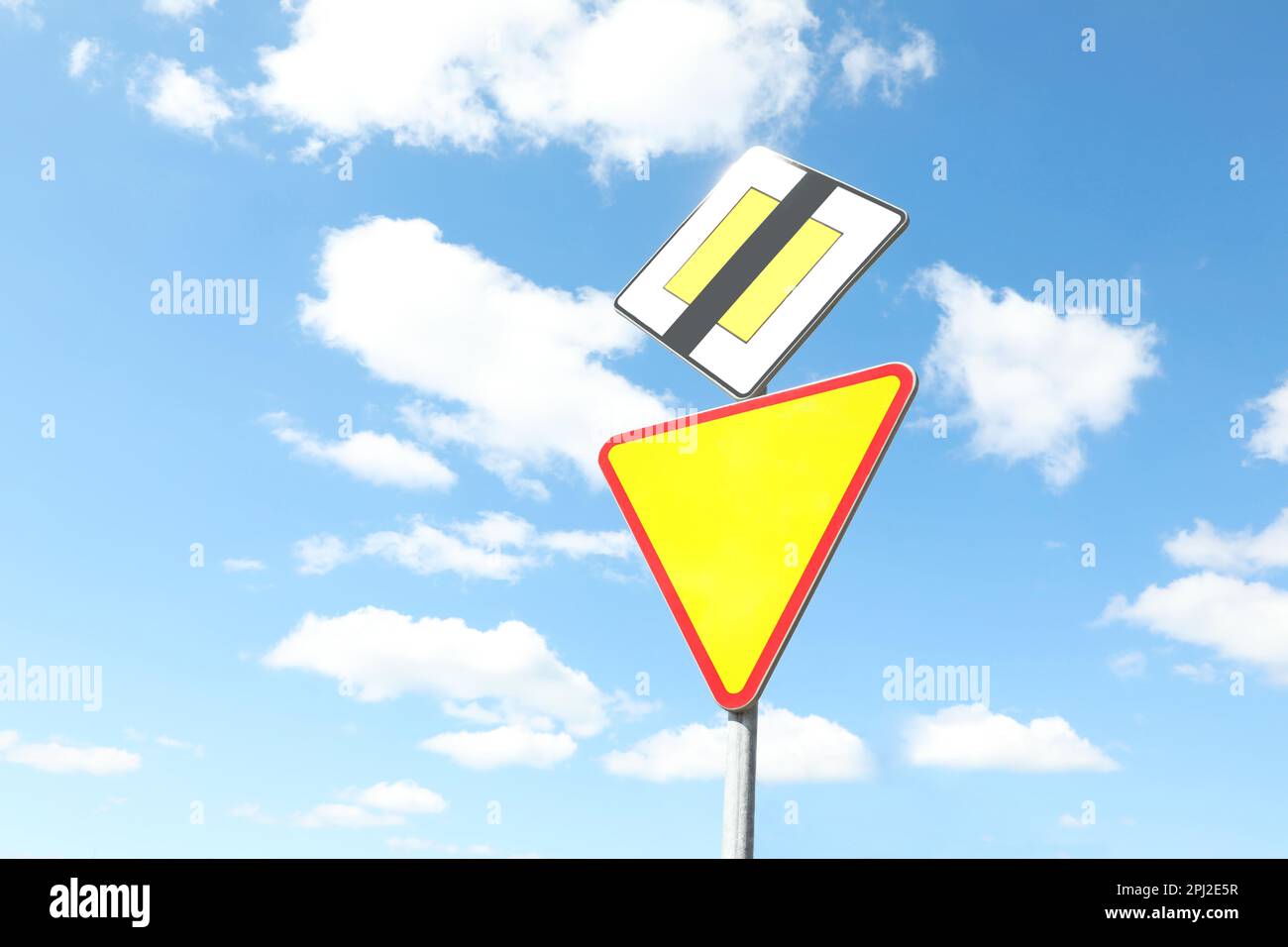 Traffic signs End Of Priority Road and Yield against blue sky, space ...