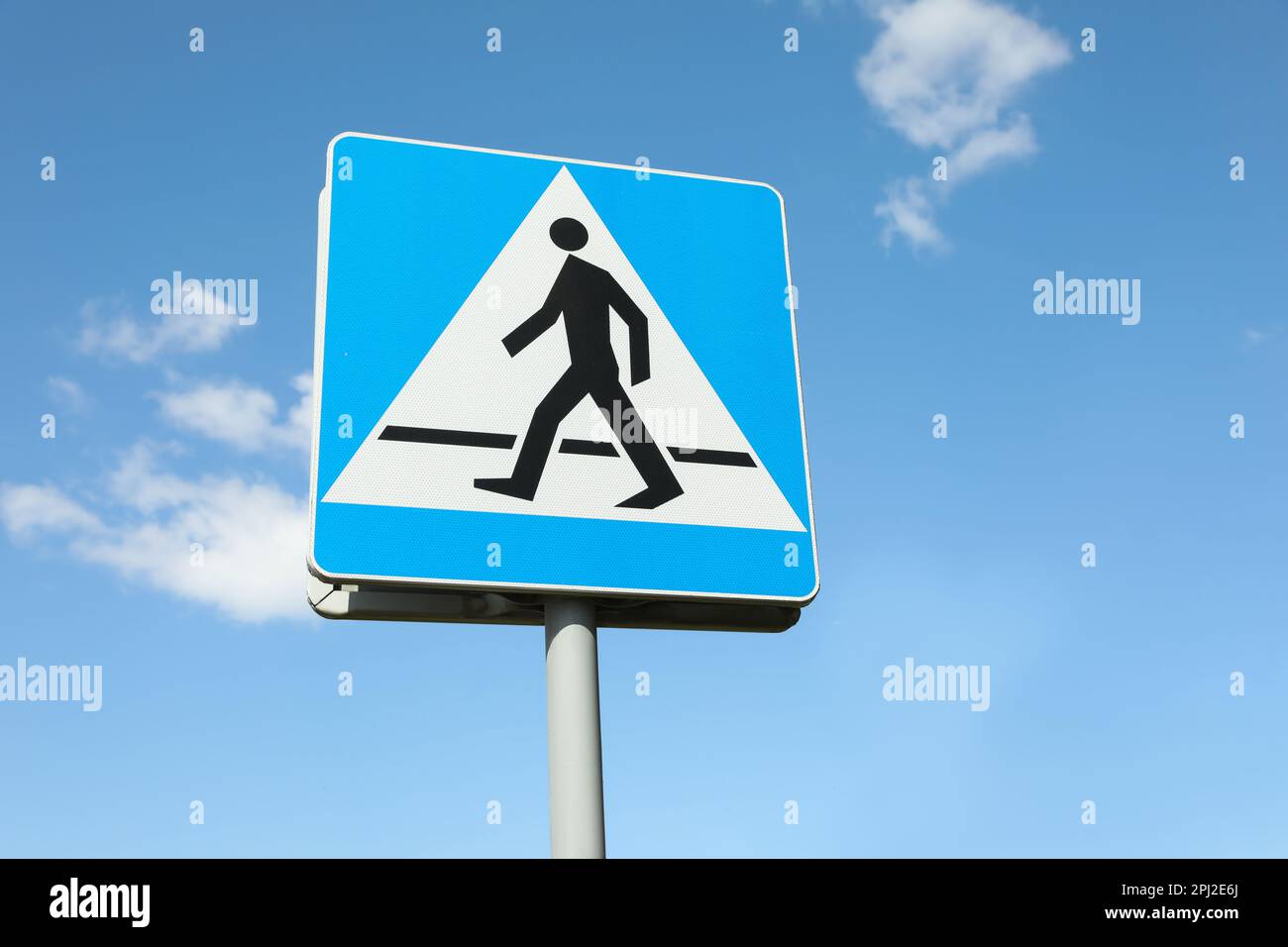 Traffic sign Pedestrian Crossing against blue sky, low angle view Stock ...