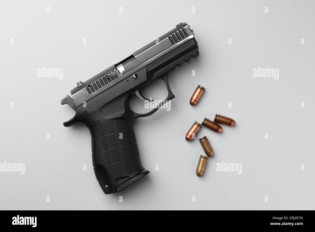Semi-automatic pistol and bullets on light background, flat lay Stock ...