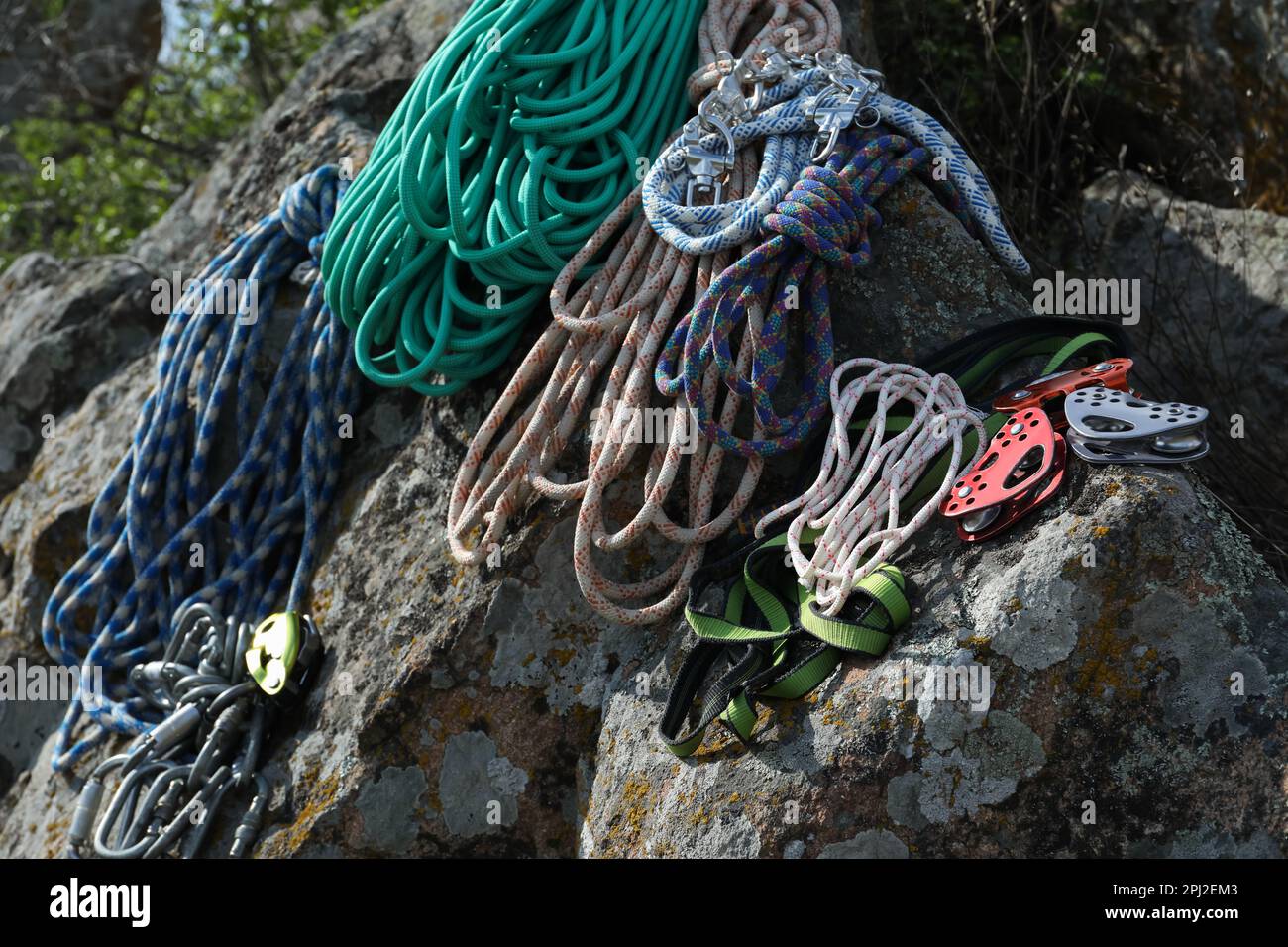 Different ropes and other climbing equipment on rocks outdoors Stock ...