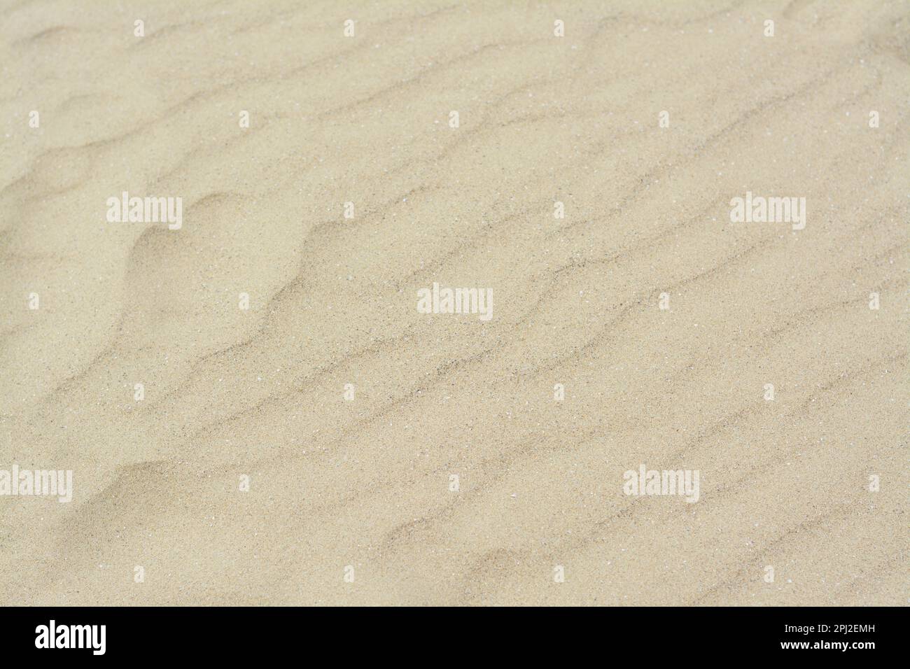 Dry beach sand with wave pattern as background Stock Photo - Alamy