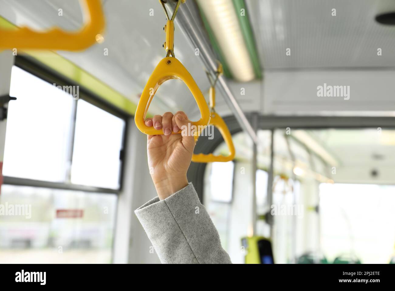 Woman holding bus handle hi-res stock photography and images - Alamy