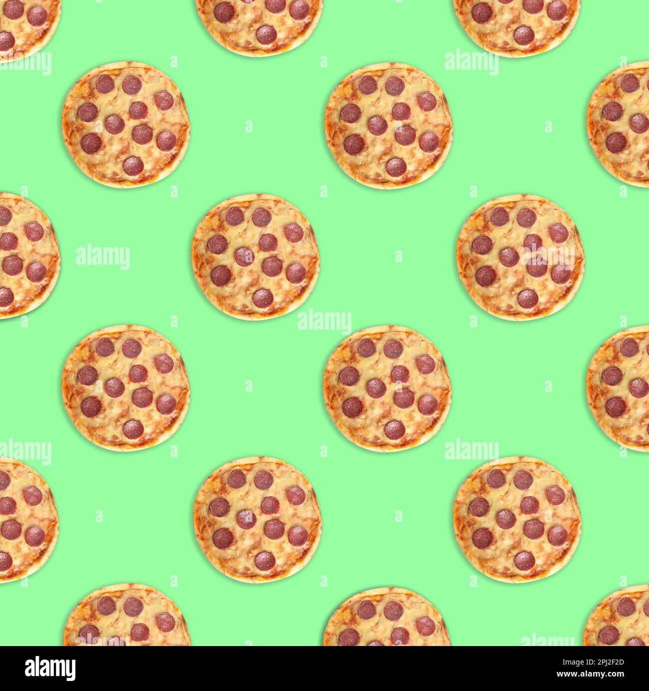 Many delicious pepperoni pizzas on green background, flat lay. Seamless ...