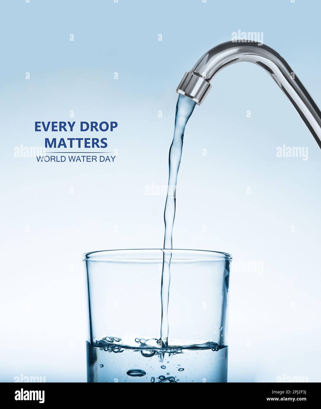 Every drop matters. Filling glass with water from tap on light blue ...