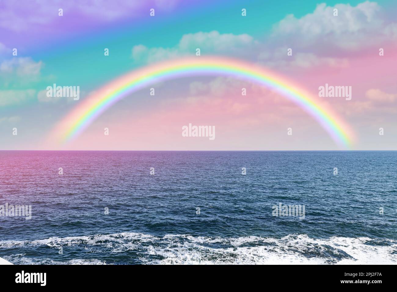 Beautiful view of colorful rainbow in sky over sea Stock Photo - Alamy