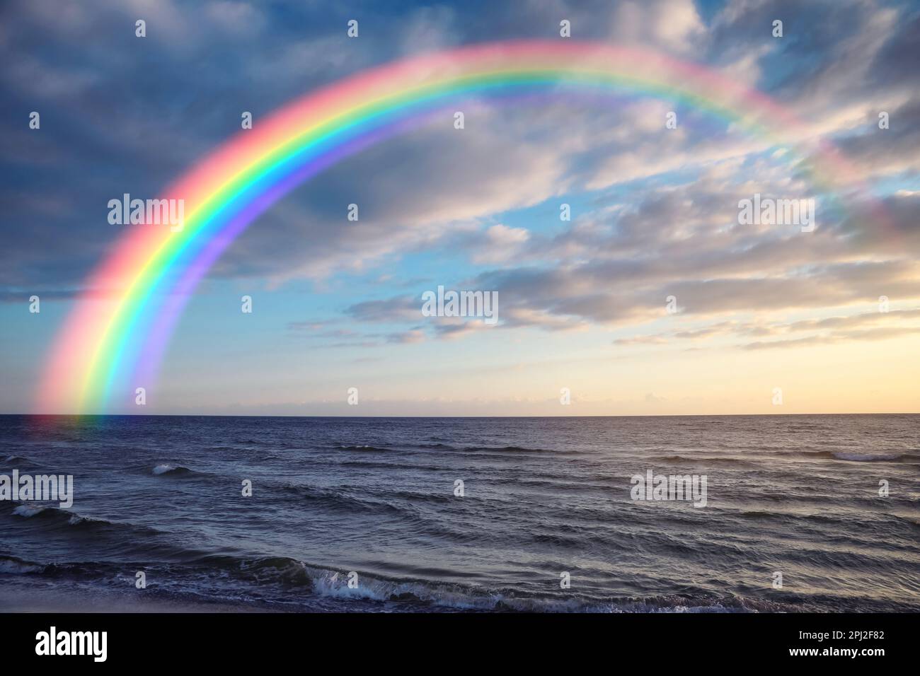 Beautiful view of colorful rainbow in sky over sea Stock Photo - Alamy