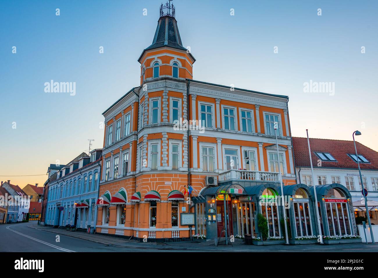Svendborg, Denmark, June 20, 2022: Sunset view of a street in center of ...