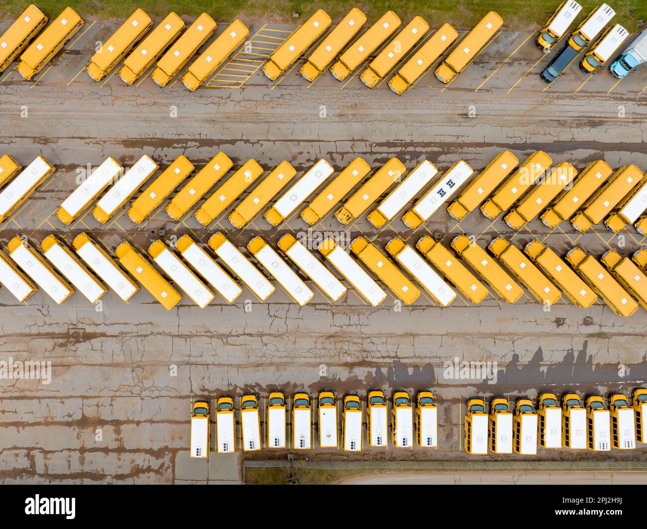 Aerial view of yellow school buses in a concrete parking lot Stock ...