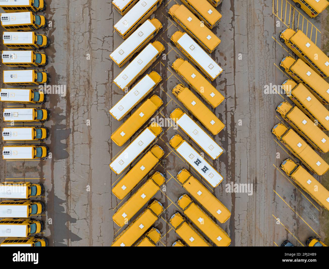 Aerial view of yellow school buses in a concrete parking lot Stock ...
