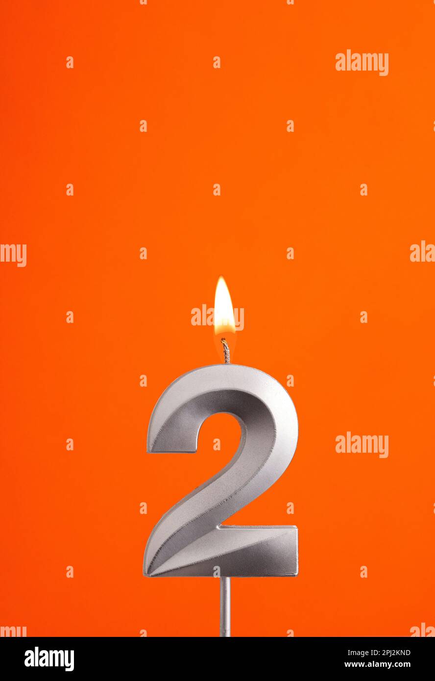 Candle number 2 - Birthday in orange foamy background Stock Photo - Alamy