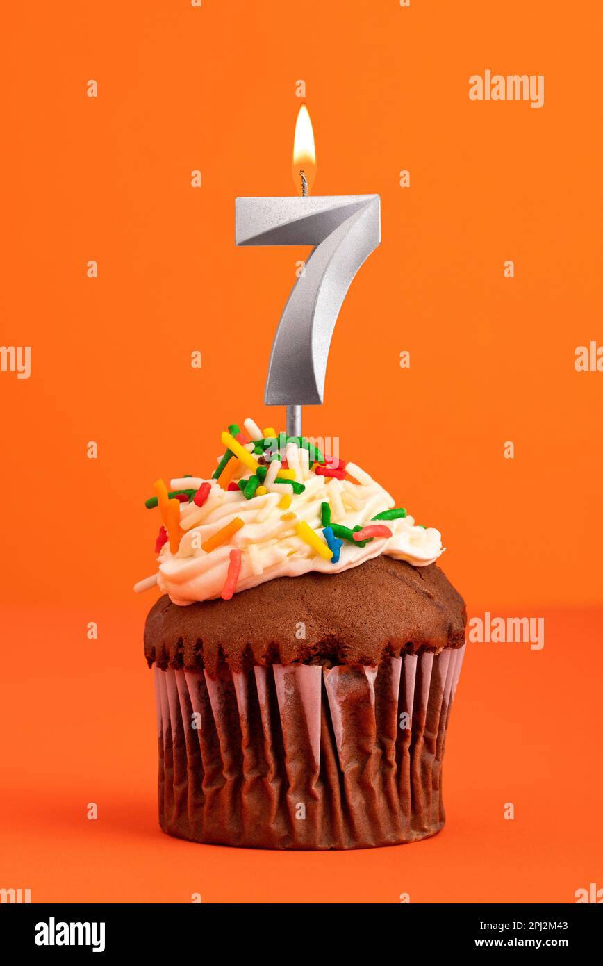 Birthday cake with burning candle number 7 hi-res stock photography and ...