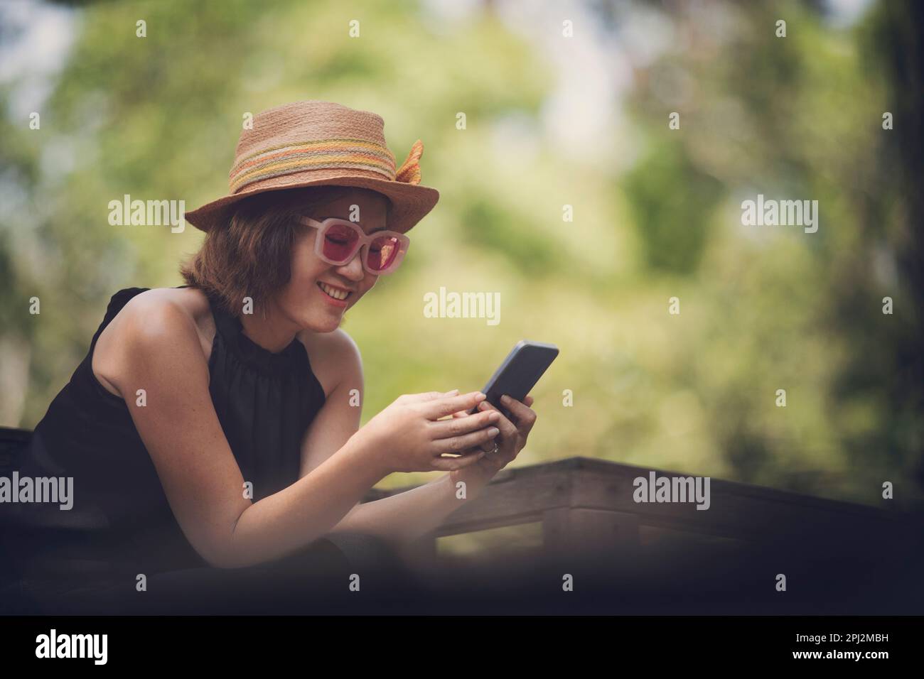 beautiful woman reading message in smart phone and smiling with ...