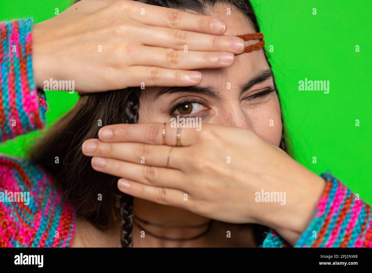 Nosy curious young woman closing eyes with hand and spying through ...