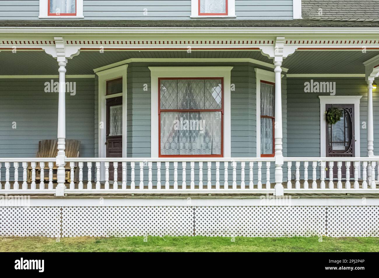 House with porch and white railings. White veranda and railing posts ...