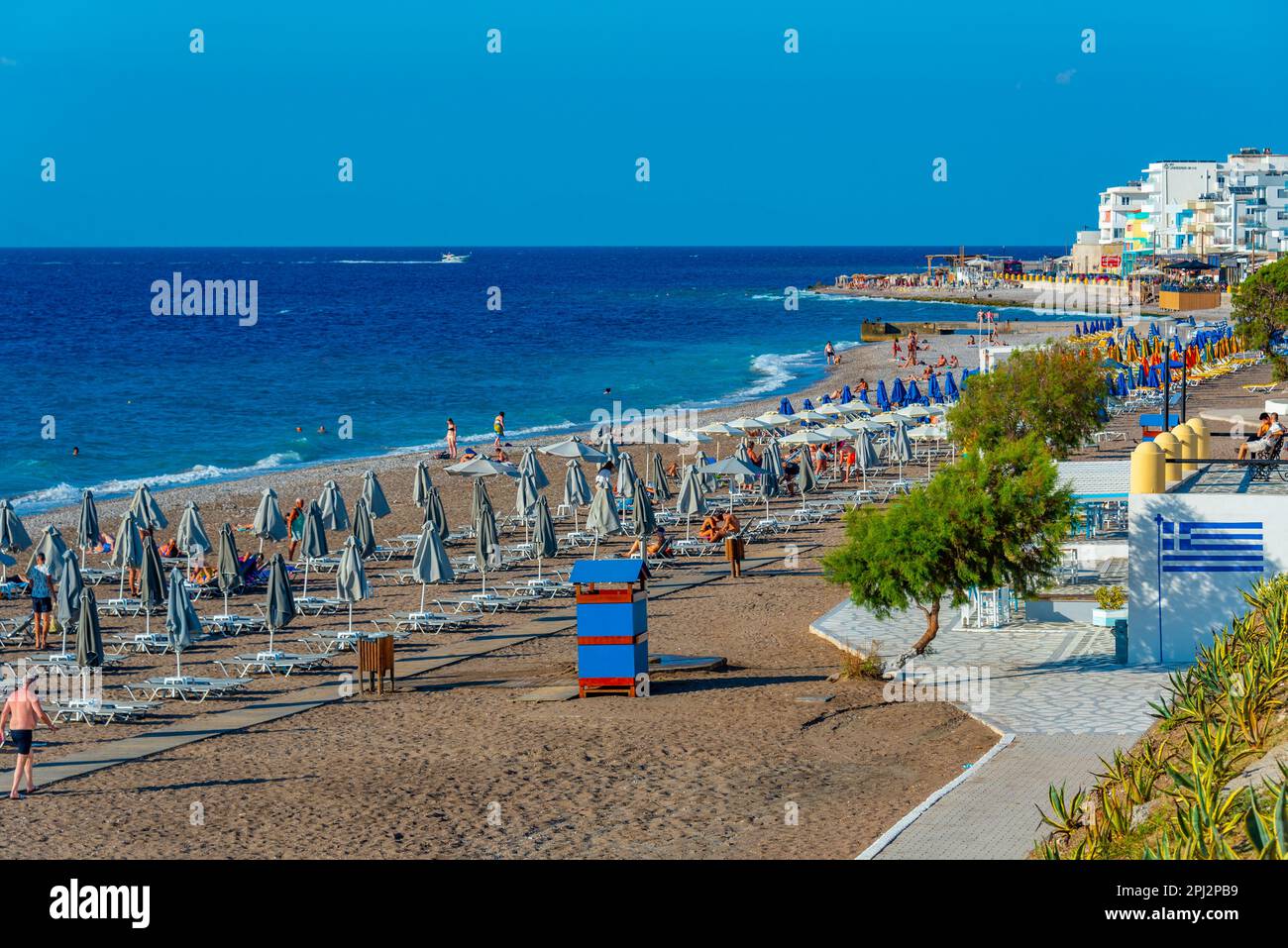 Rhodes, Greece, August 27, 2022: Sunbeds and umbrellas at a beach in ...