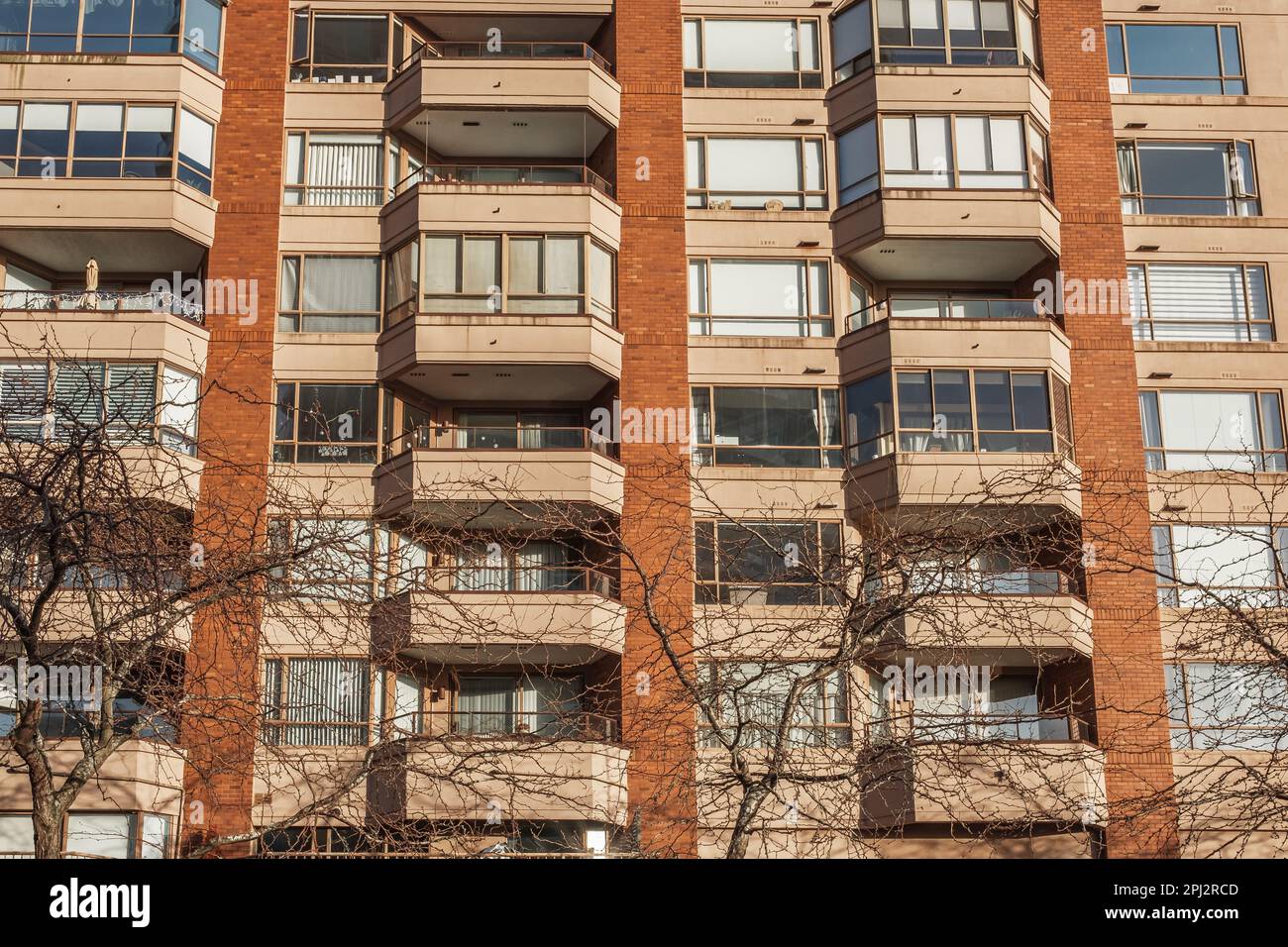 Tall bricks building facade with many windows and balconies in ...